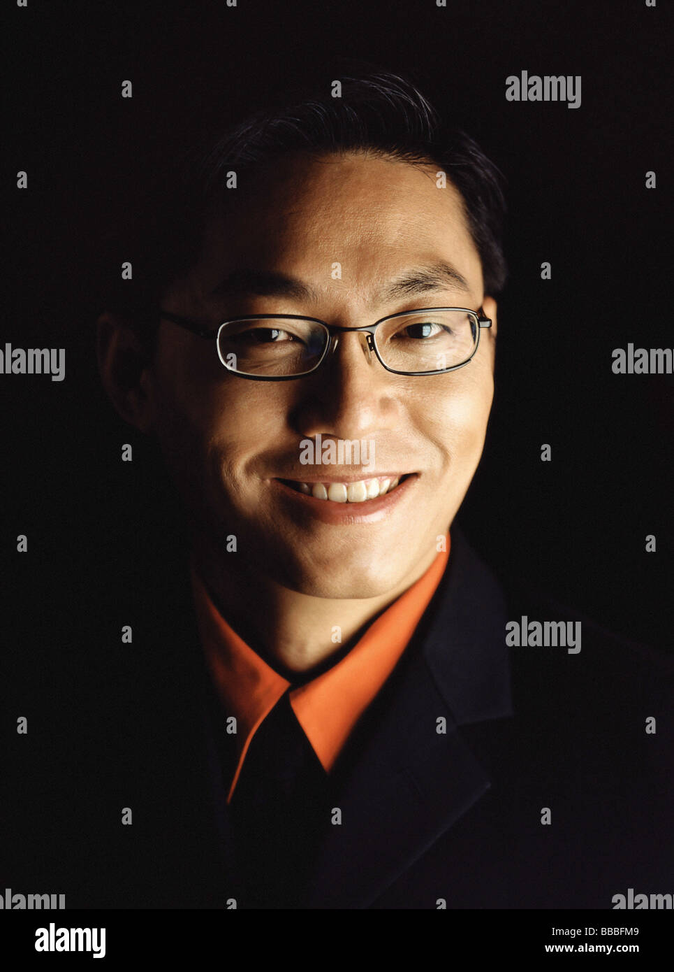 Male executive smiling, portrait, black background Stock Photo - Alamy