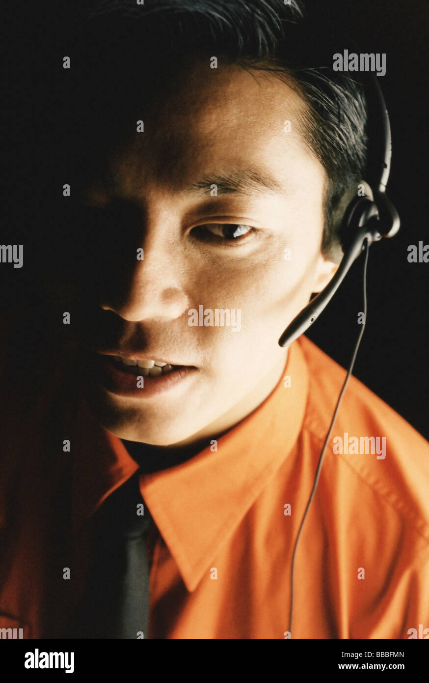 Male executive using telephone headset, portrait Stock Photo - Alamy
