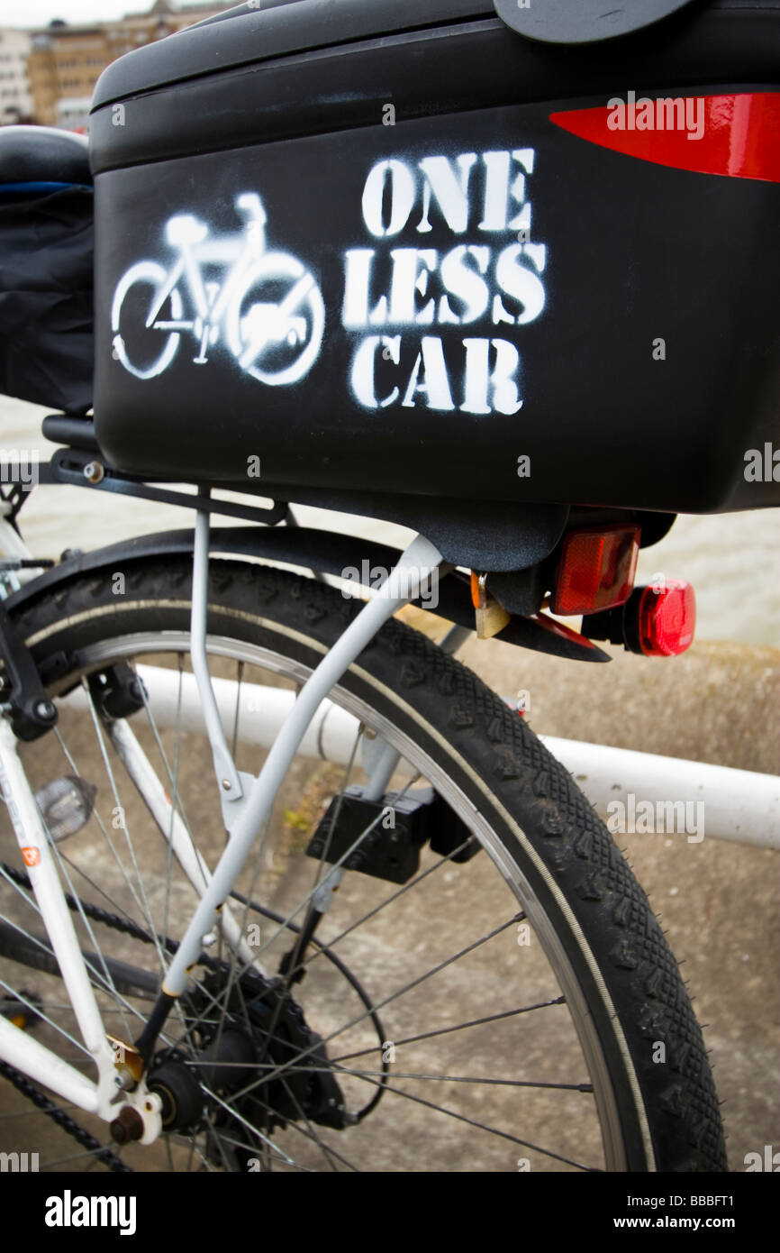 Box on a bicycle spray painted with a stencil saying One Less Car ...