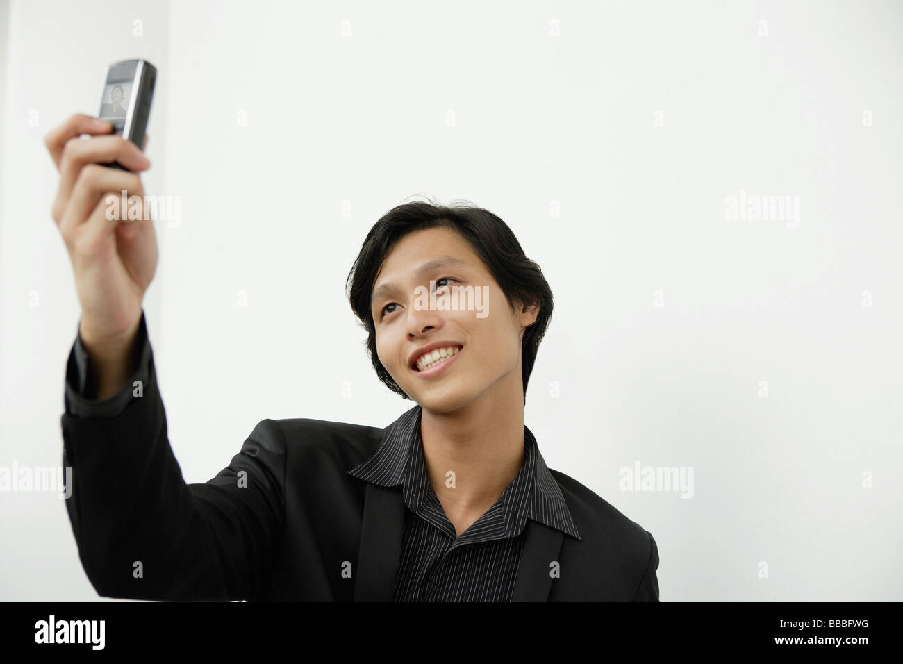 Businessman using camera phone, taking a picture Stock Photo - Alamy