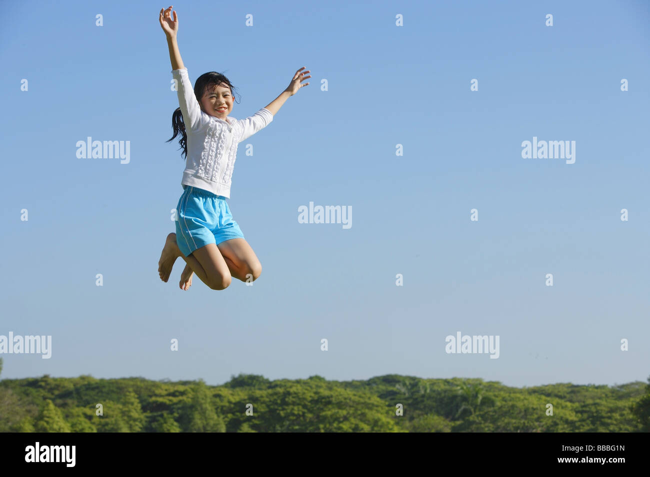 Girl jumping in mid air Stock Photo - Alamy