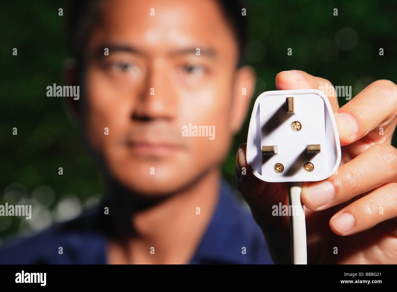 Man holding plug at camera Stock Photo - Alamy