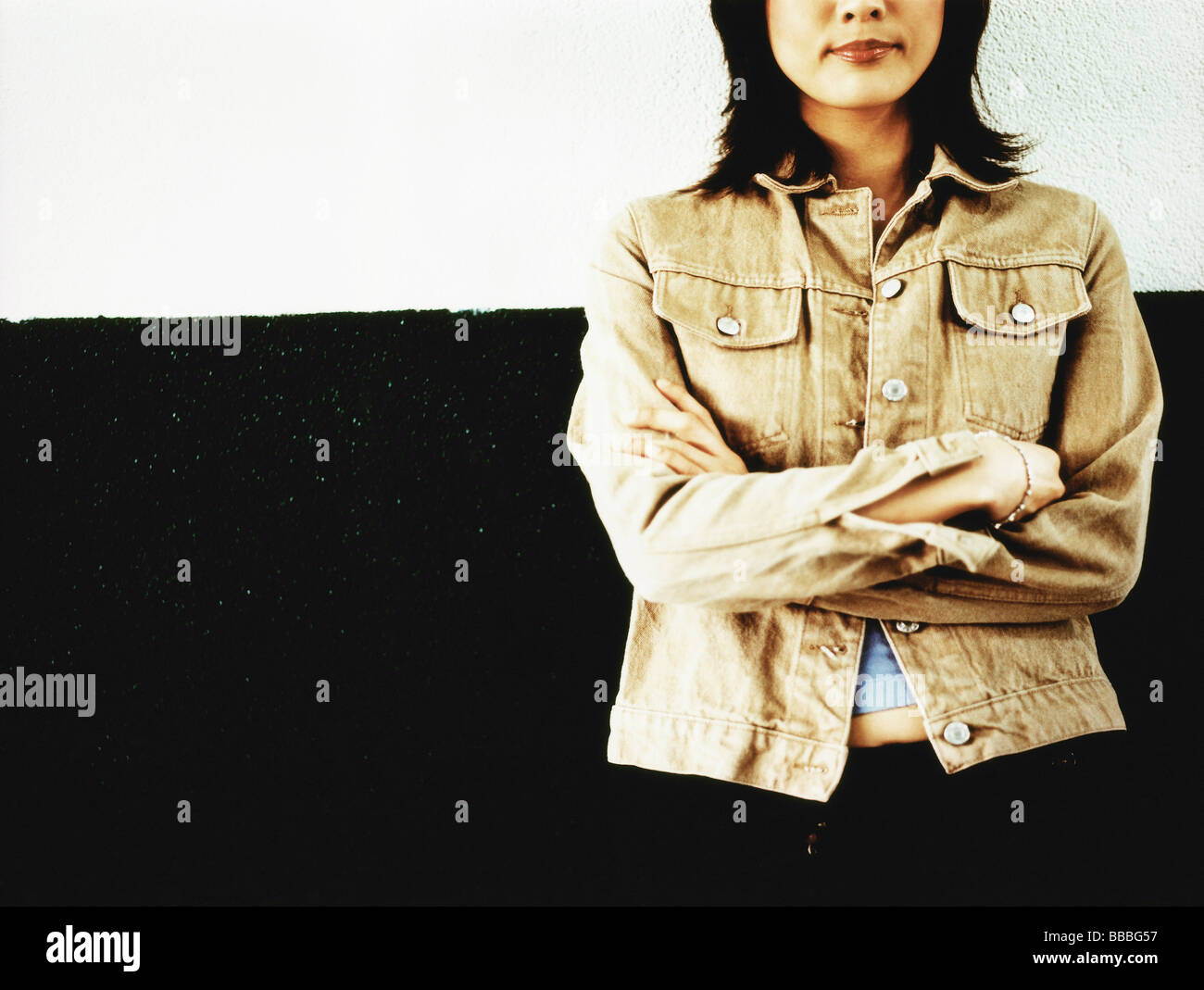 Lower torso of woman standing with arms crossed Stock Photo - Alamy