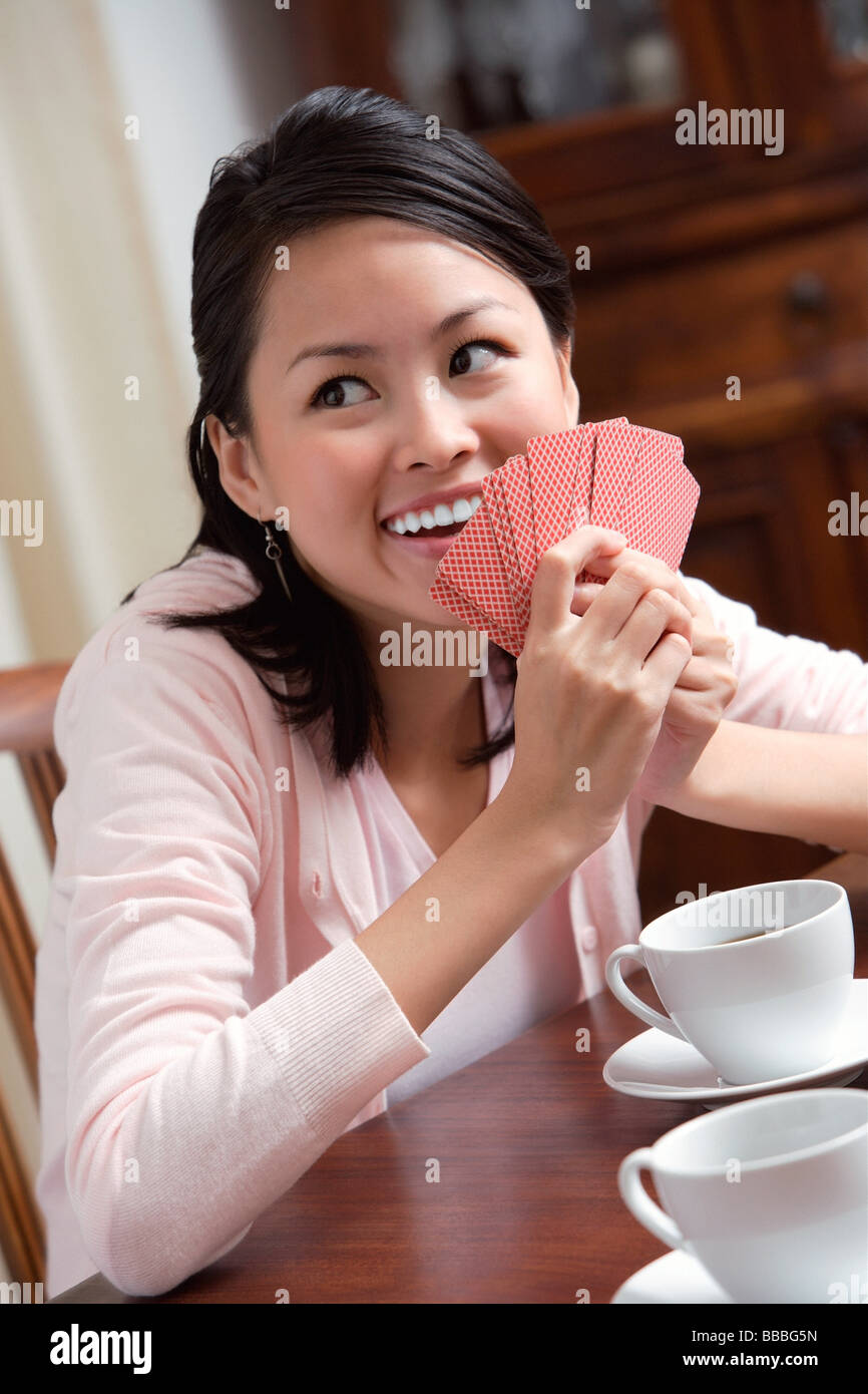 Young woman playing cards Stock Photo - Alamy