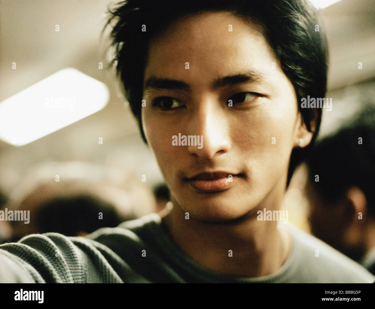 Young man looking off camera Stock Photo - Alamy