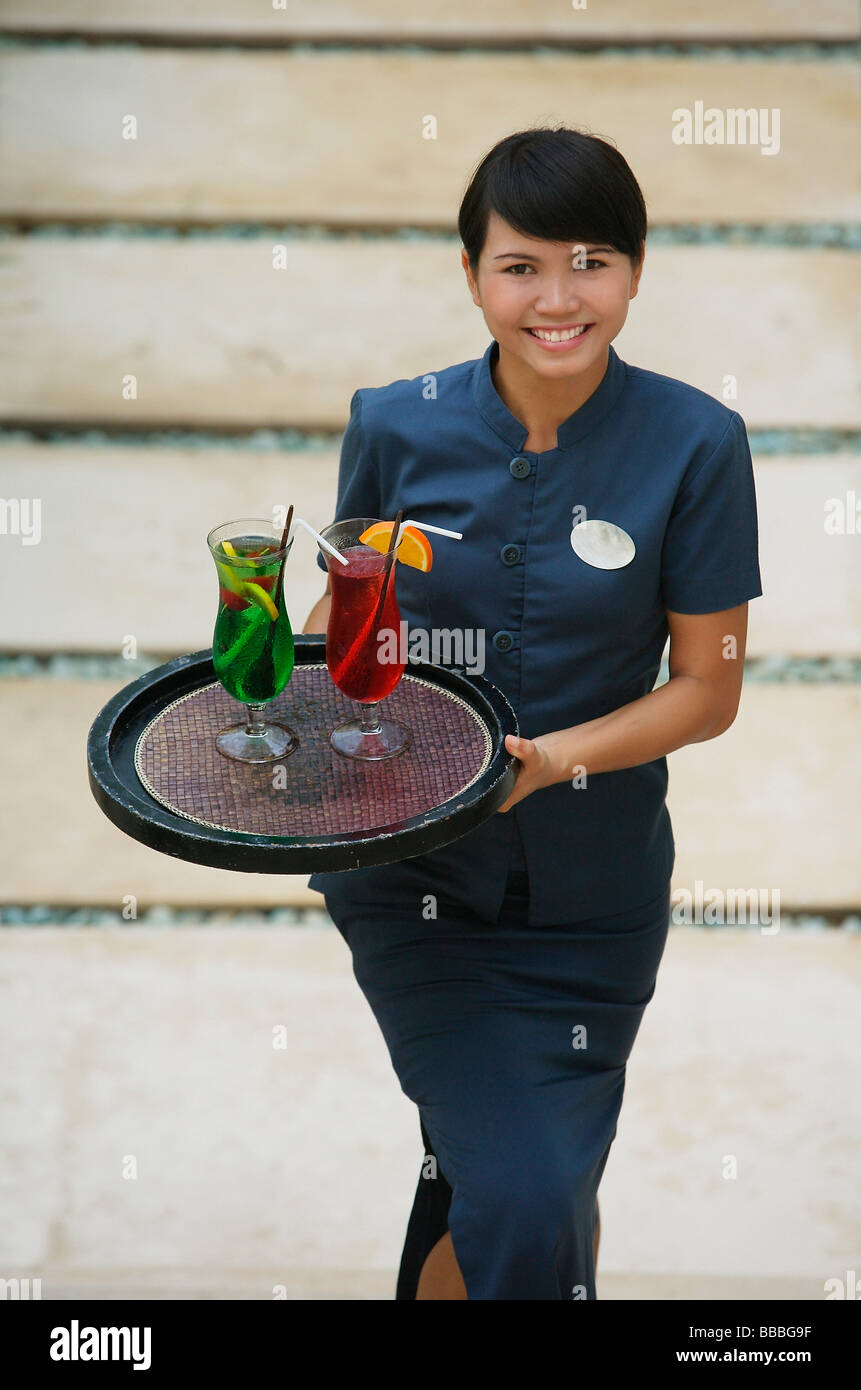 Balinese waitress carrying cocktails Stock Photo - Alamy