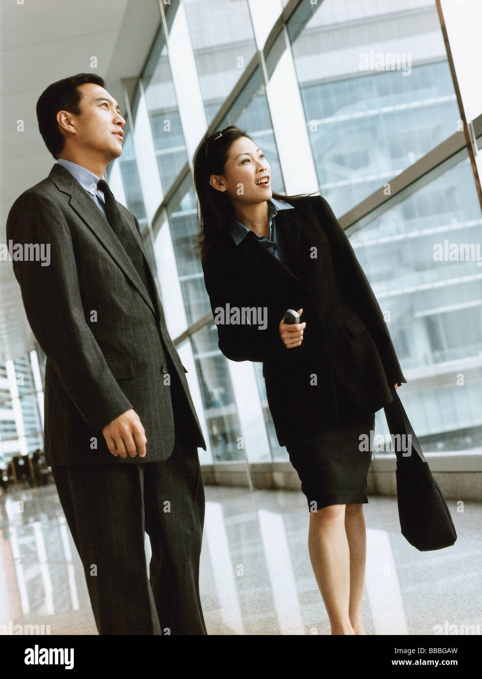 Executive pair looking out window Stock Photo - Alamy