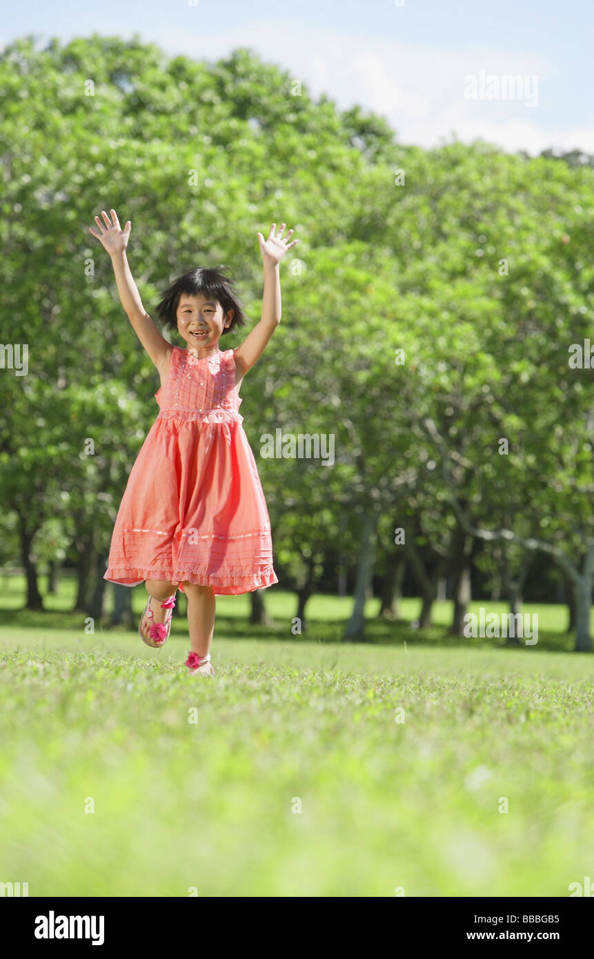 Girl running towards camera, arms outstretched, smiling Stock Photo - Alamy