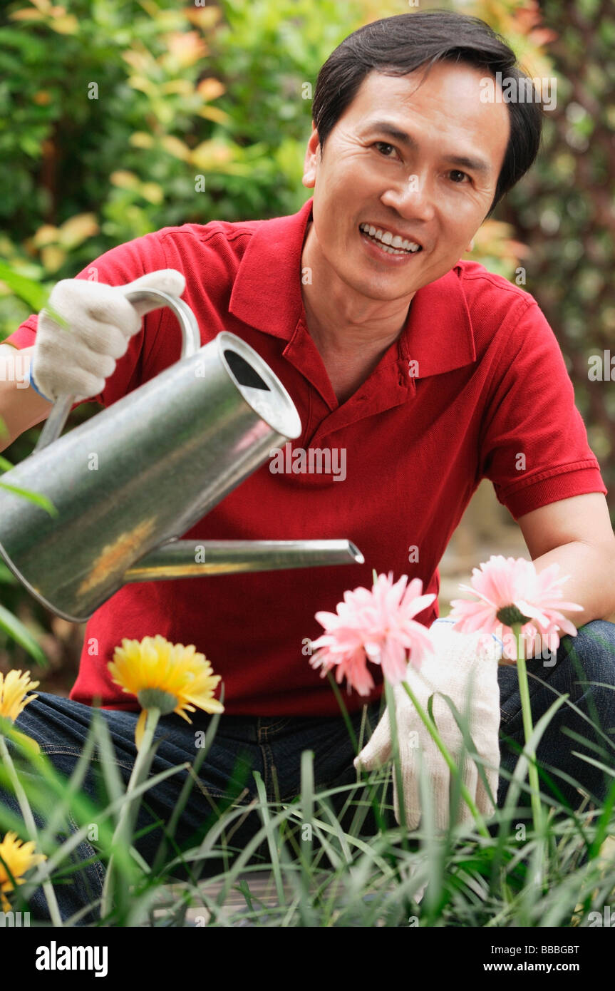 Man watering plants in the garden Stock Photo - Alamy