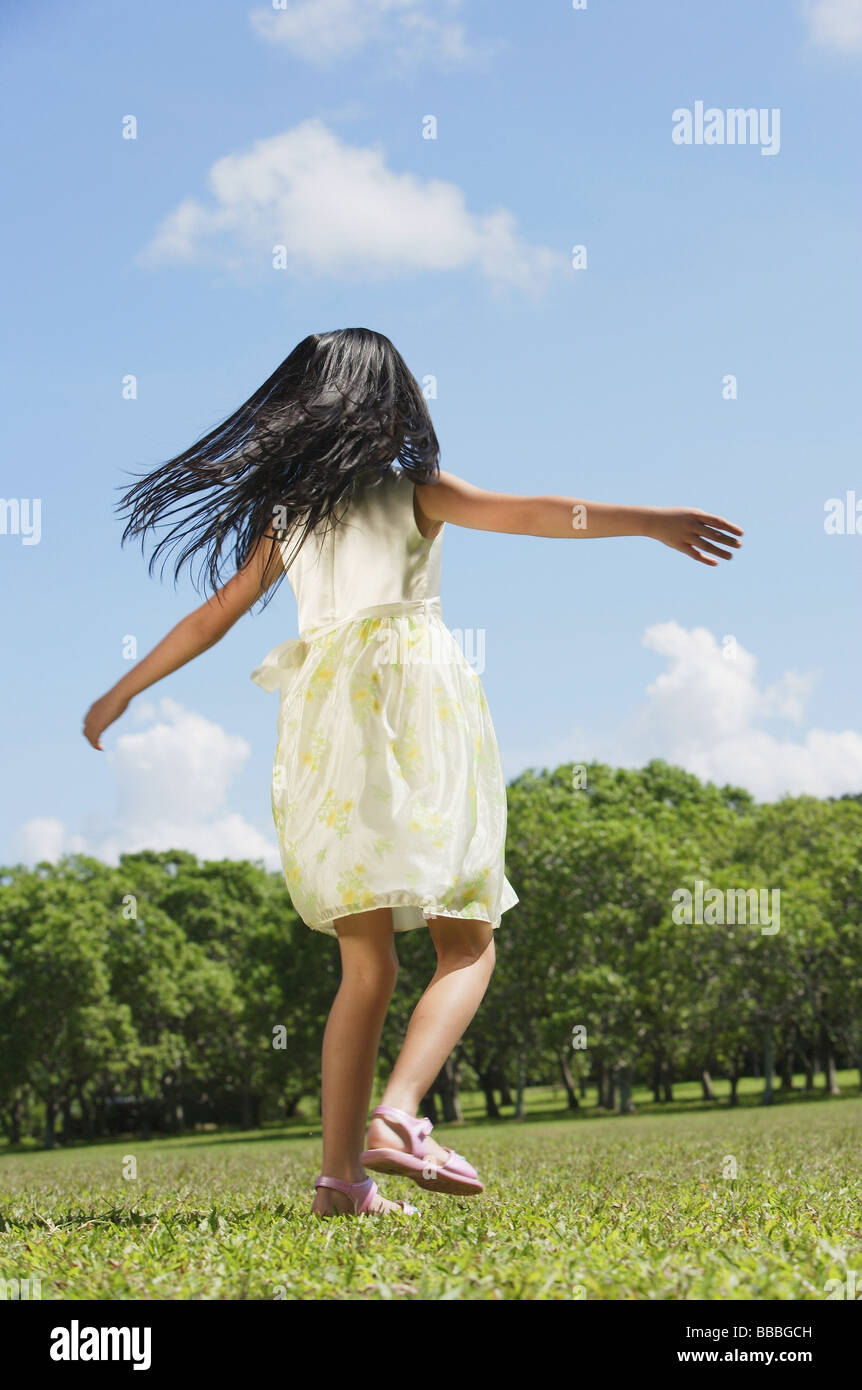 Girl running in park, rear view Stock Photo - Alamy