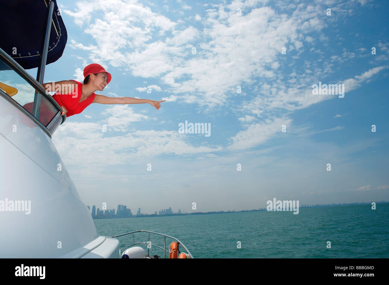 Young woman on yacht, pointing into distance Stock Photo - Alamy