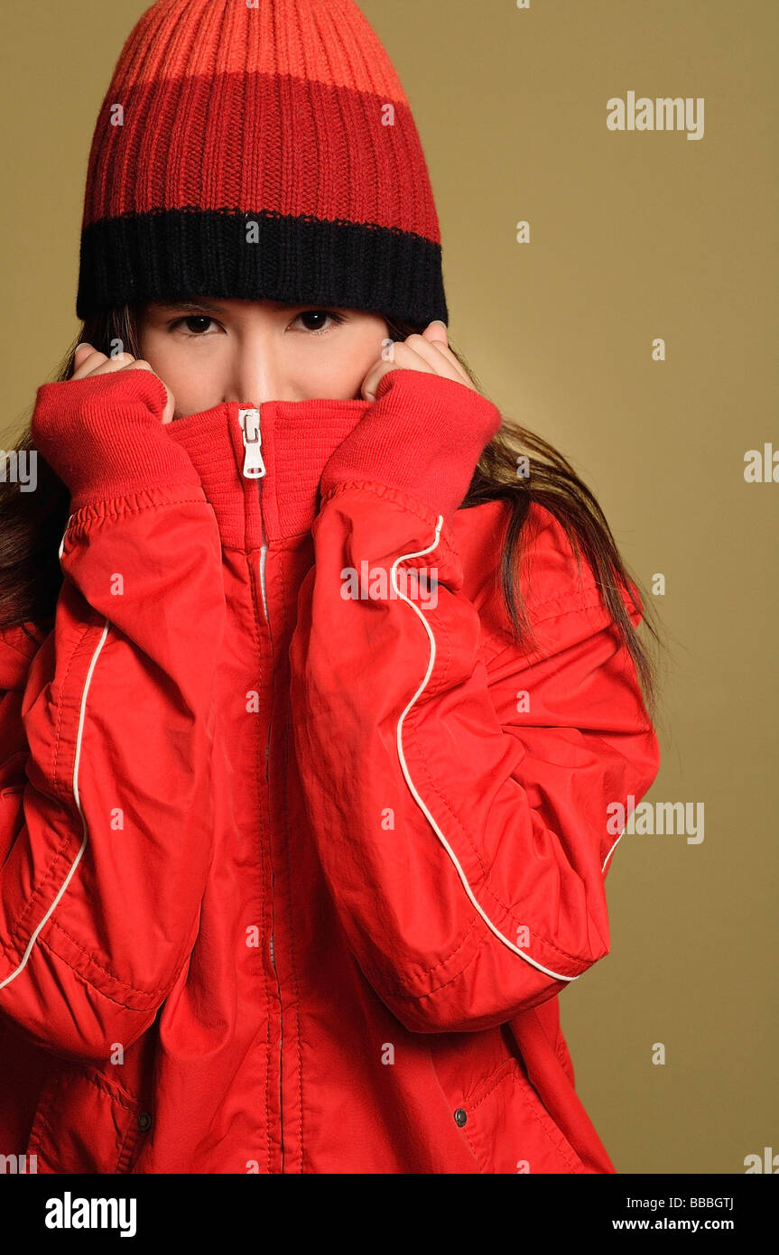 Young woman covering face and looking at camera Stock Photo - Alamy