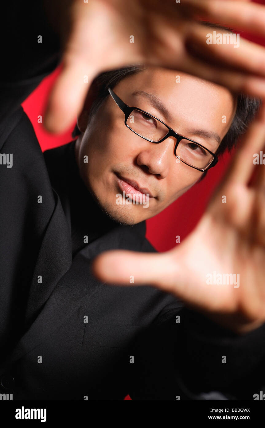 Man looking at camera, making finger frame Stock Photo - Alamy