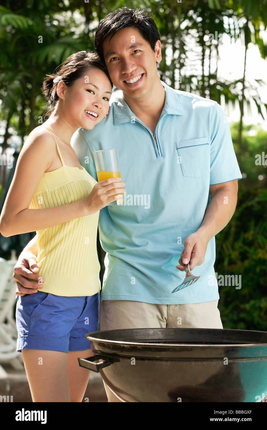 Happy young chinese couple barbecuing hi-res stock photography and ...