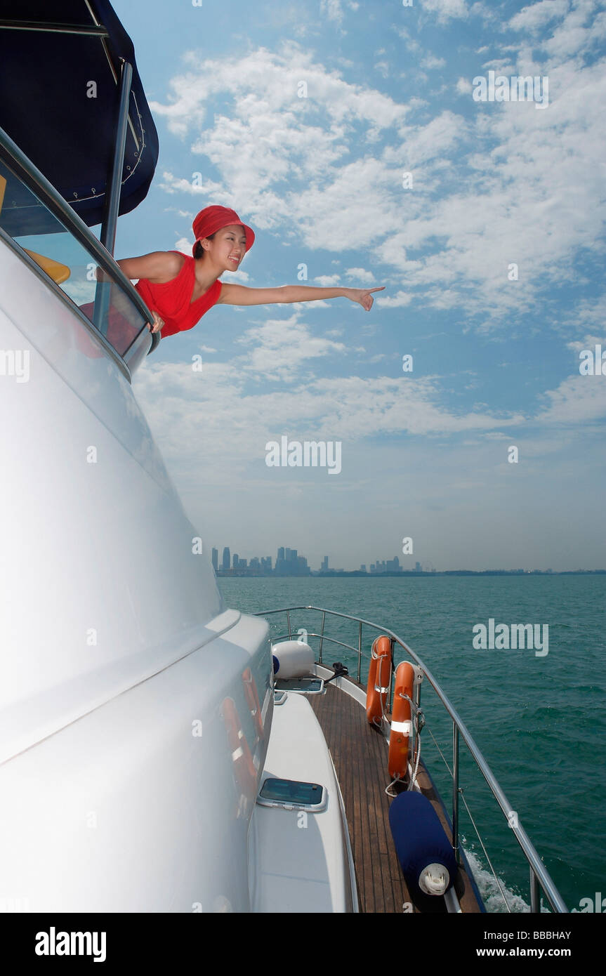 Young woman on yacht, pointing into distance Stock Photo - Alamy