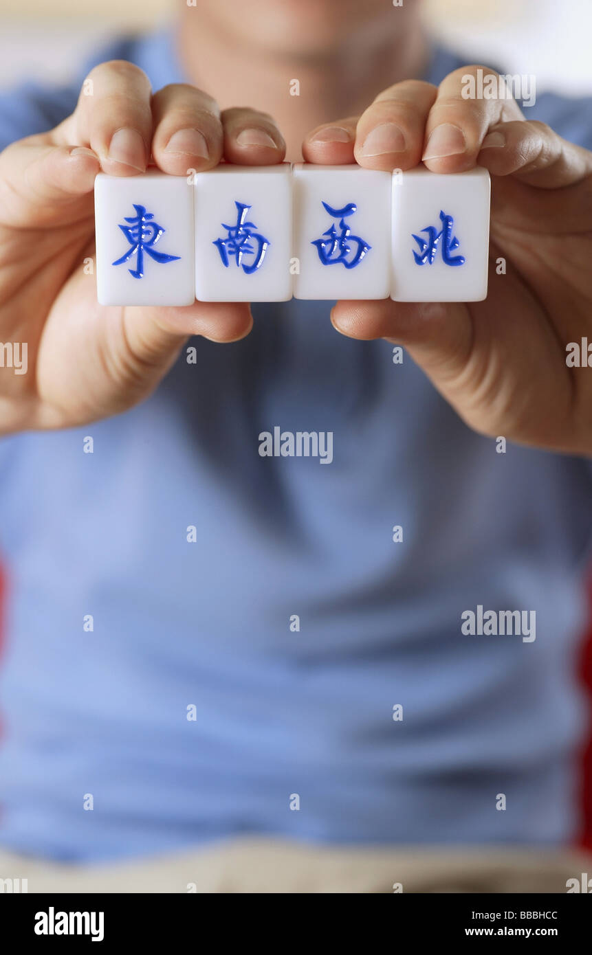 Close up of mahjong tiles with Chinese characters for East, South, West ...