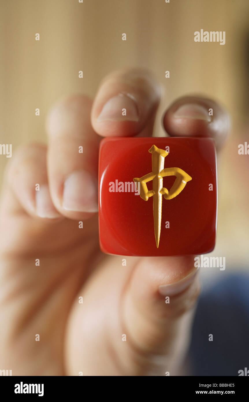 Close-up of hand holding red mahjong tile with Chinese script Stock ...