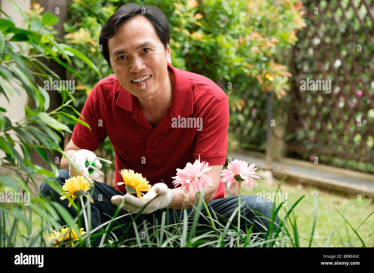 Man gardening and smiling at camera Stock Photo - Alamy