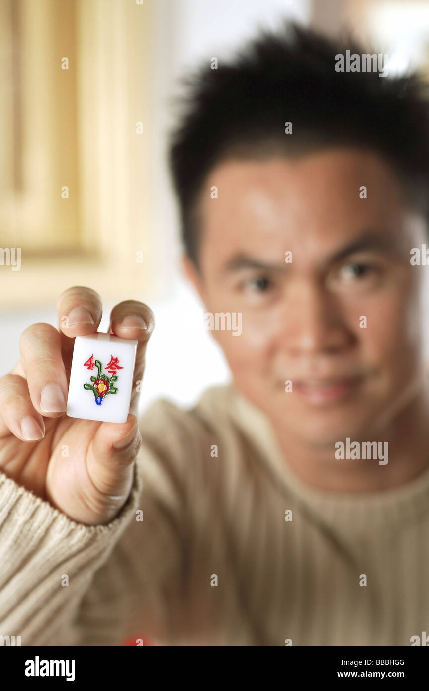 Man holding mahjong tile with the Chinese script for Winter Stock Photo ...