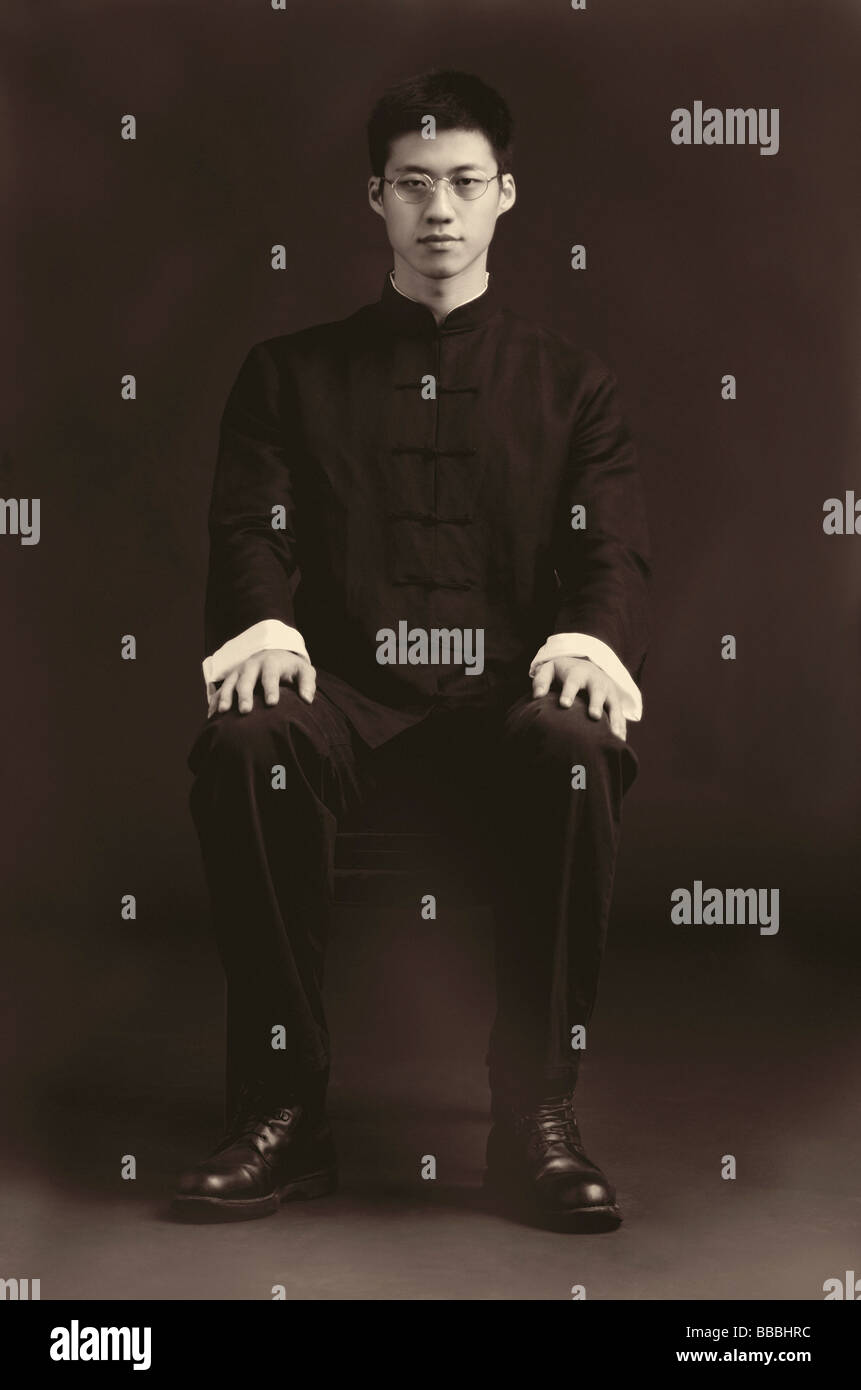 Man sitting for studio portrait Stock Photo - Alamy
