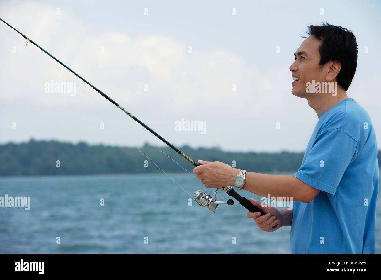 Man fishing in the sea Stock Photo - Alamy
