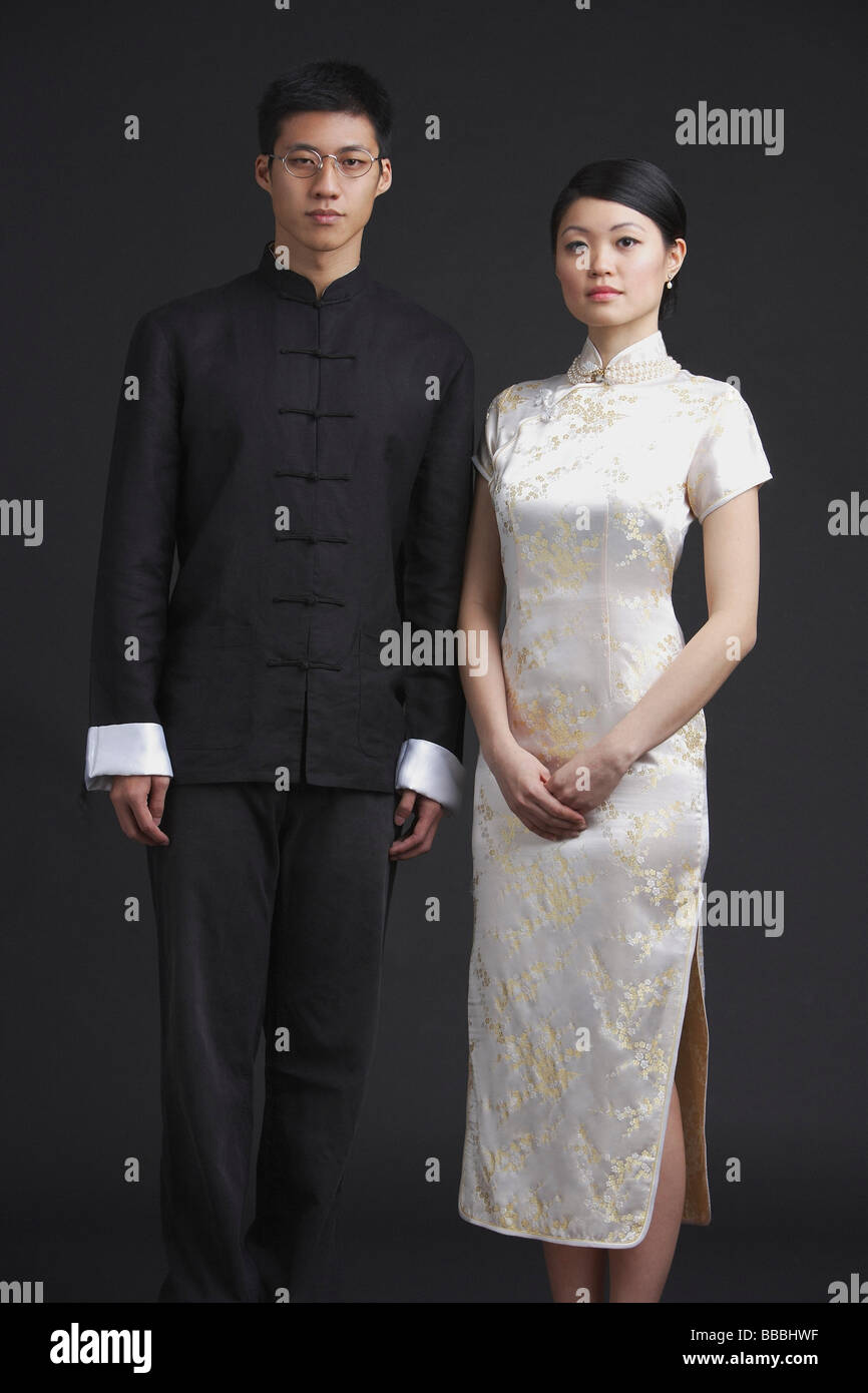 Couple dressed in traditional Chinese attire, posing for studio ...