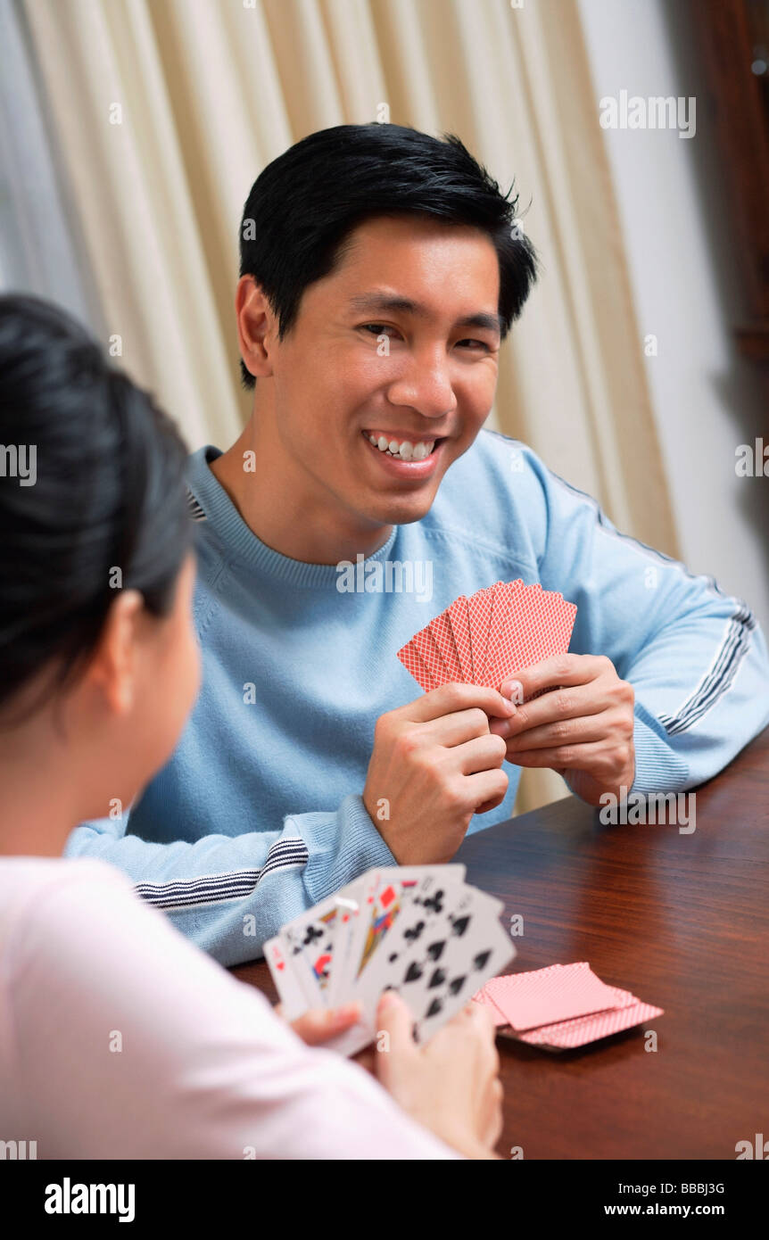 Young couple playing cards Stock Photo - Alamy