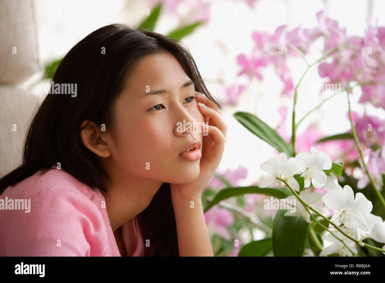 Young woman looking pensively into distance Stock Photo - Alamy
