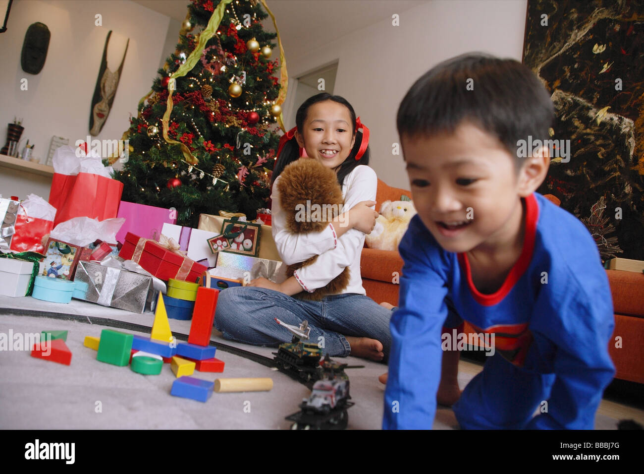 Children opening gifts on Christmas Stock Photo - Alamy