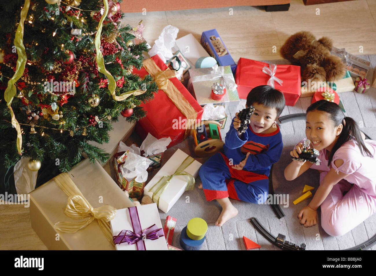 Children with opened Christmas presents, showing toys to camera Stock ...