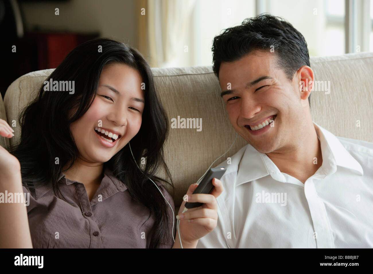 Young couple laughing together Stock Photo - Alamy