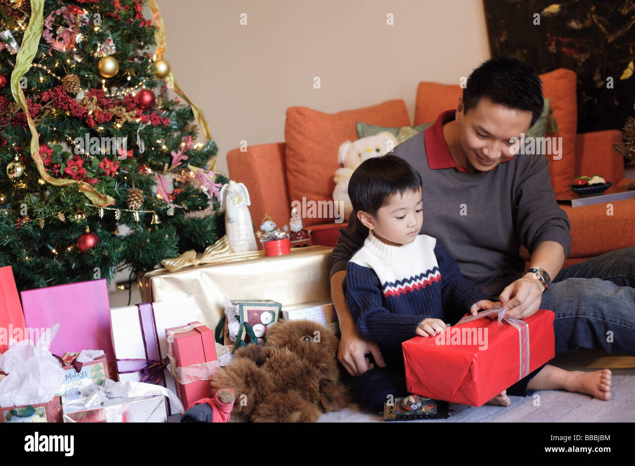 Father and son opening gifts on Christmas Stock Photo - Alamy