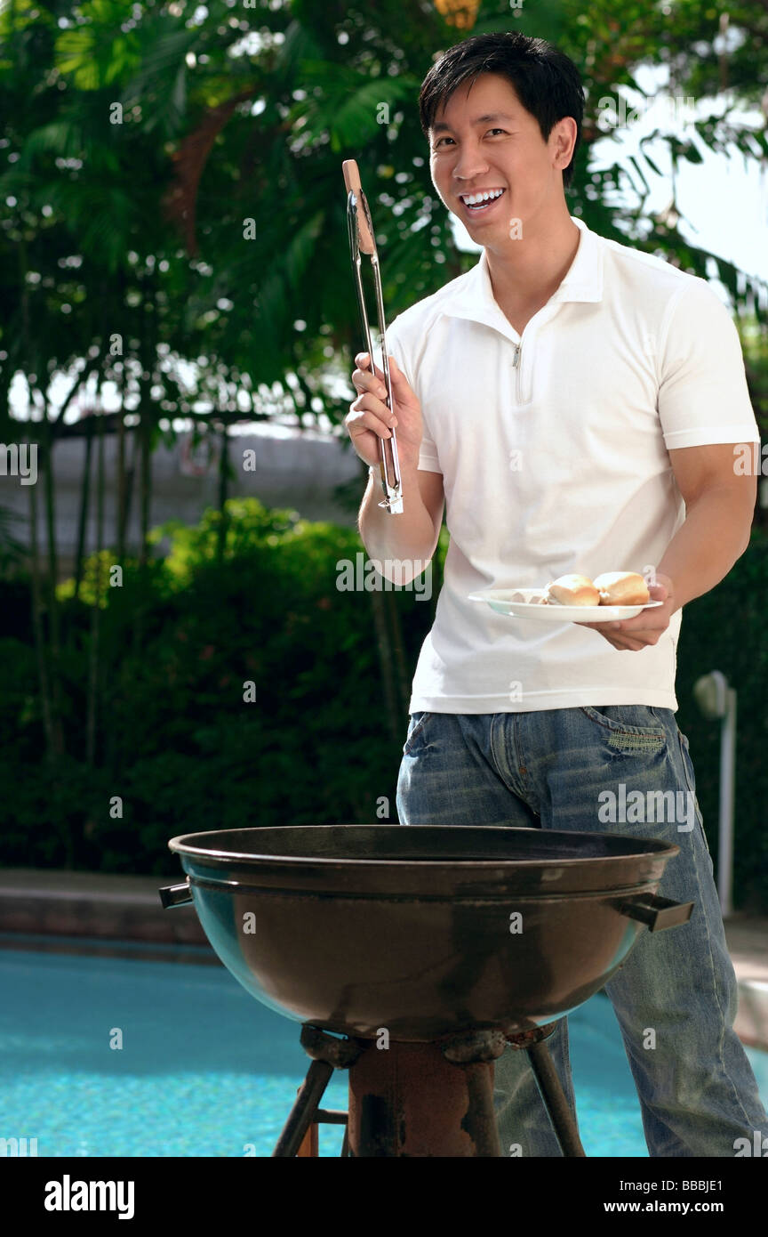 Young men enjoying a barbeque hi-res stock photography and images - Alamy