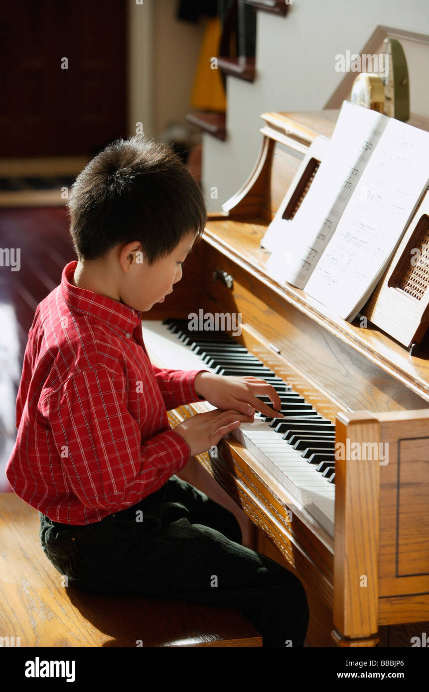 Little boy playing piano Stock Photo - Alamy