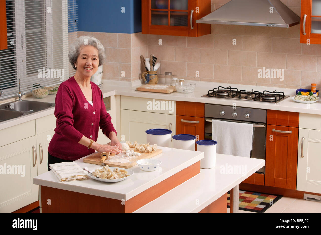 Elderly woman baking in the kitchen Stock Photo - Alamy