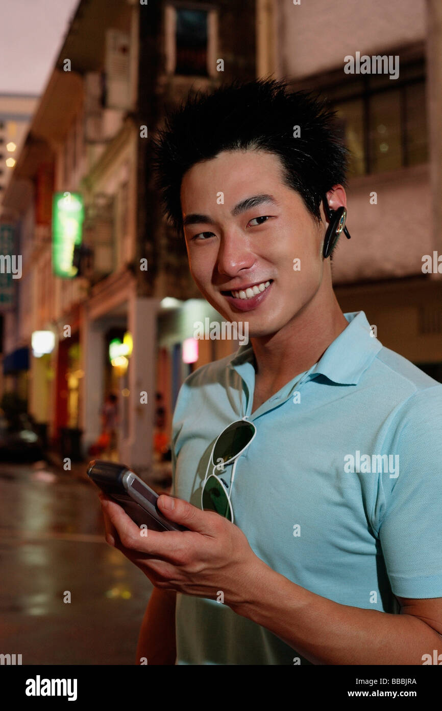 Man holding PDA and wearing Bluetooth device Stock Photo - Alamy