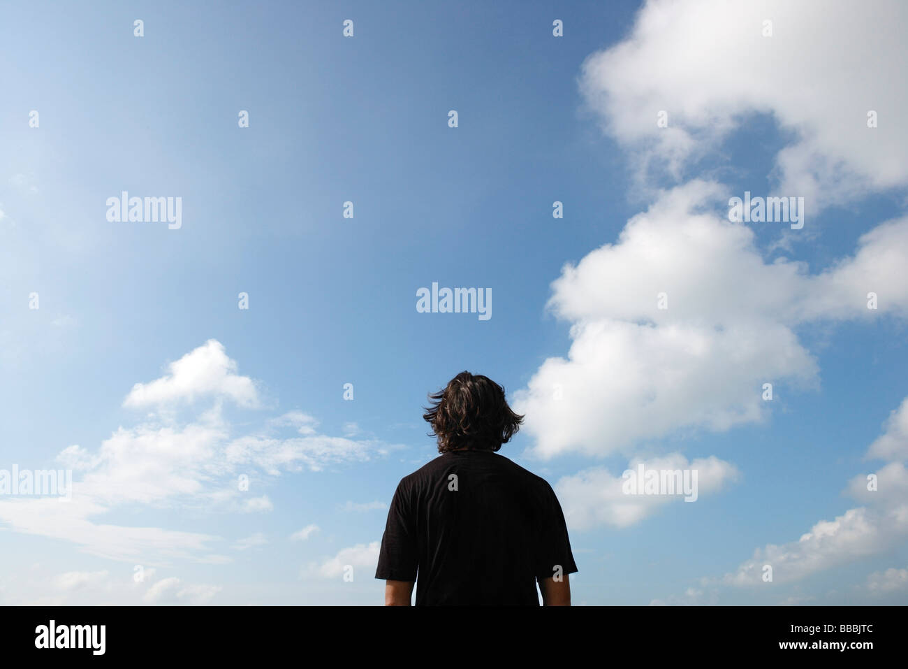 Man looking at the blue sky with clouds Stock Photo - Alamy
