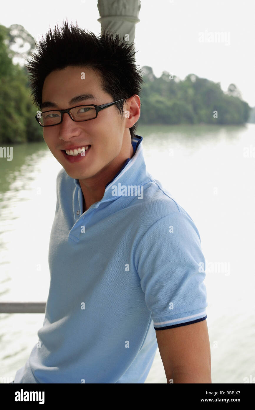Man in blue polo shirt, smiling, river behind him Stock Photo - Alamy