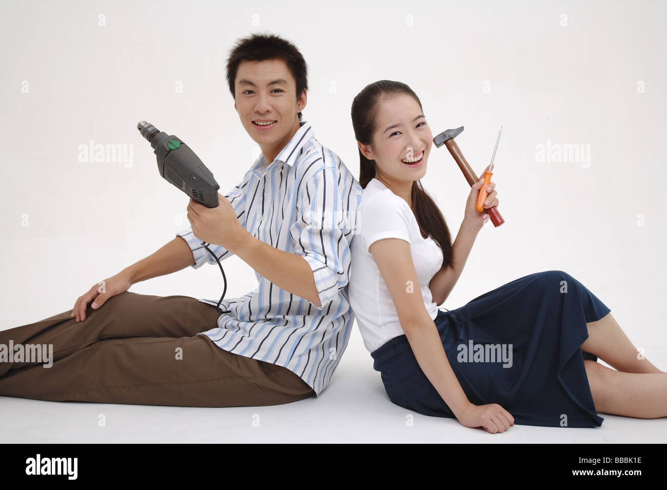 Young woman holding hammer drill hi-res stock photography and images ...