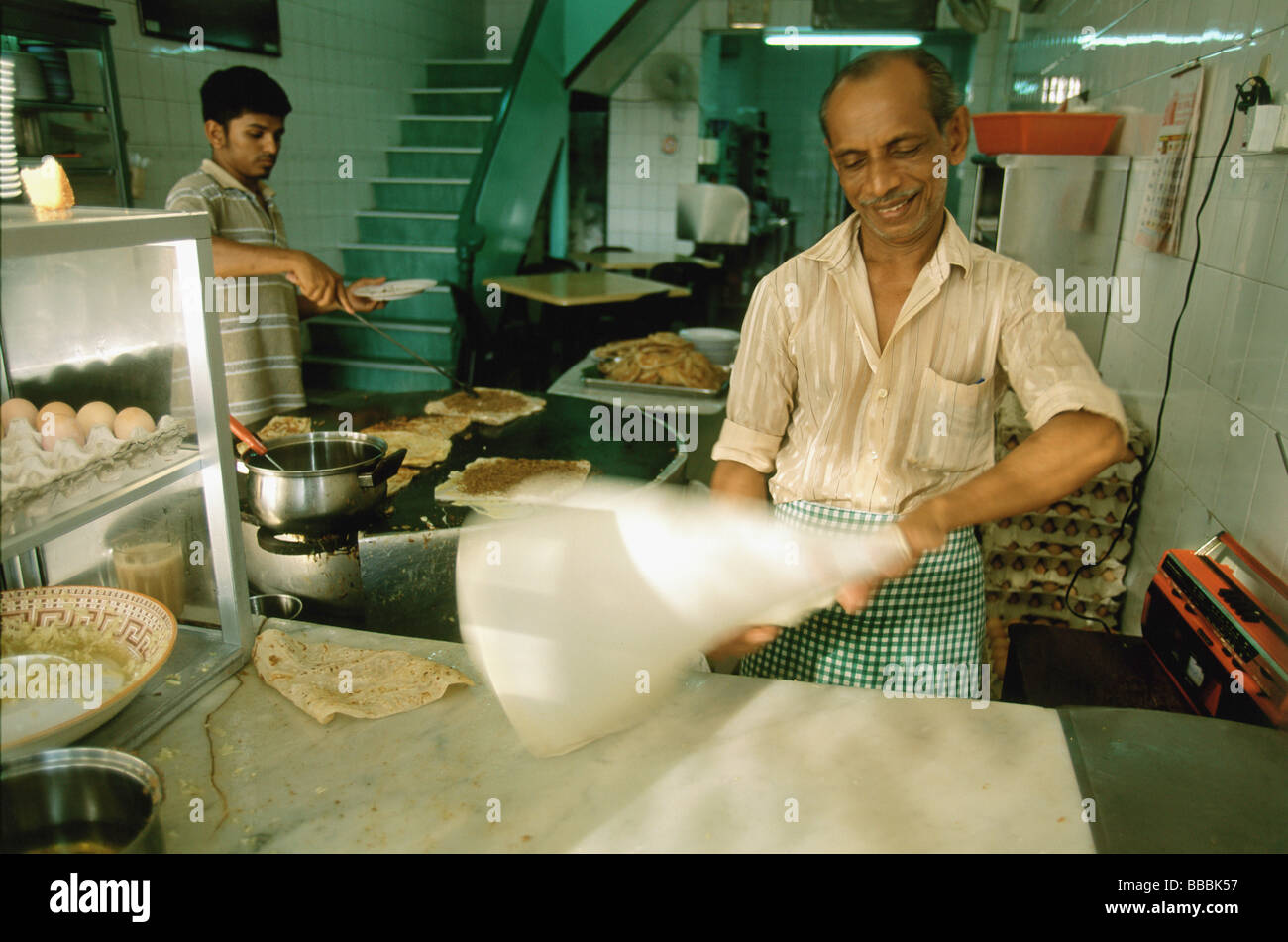 Singapore, a Muslim chef tossing murtabak, a thick pancake stuffed with ...
