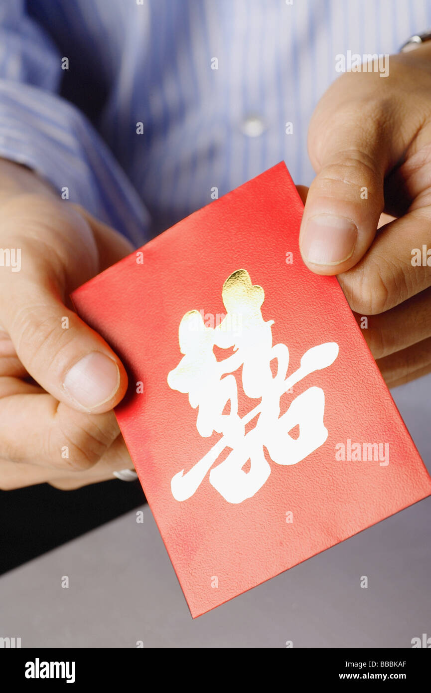 Red packet with Chinese calligraphy meaning Joyous Stock Photo - Alamy
