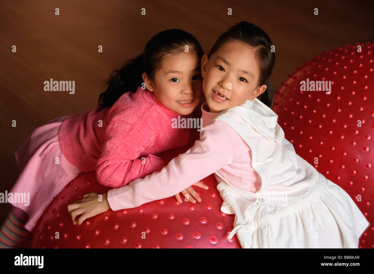 Two girls smiling at camera Stock Photo - Alamy