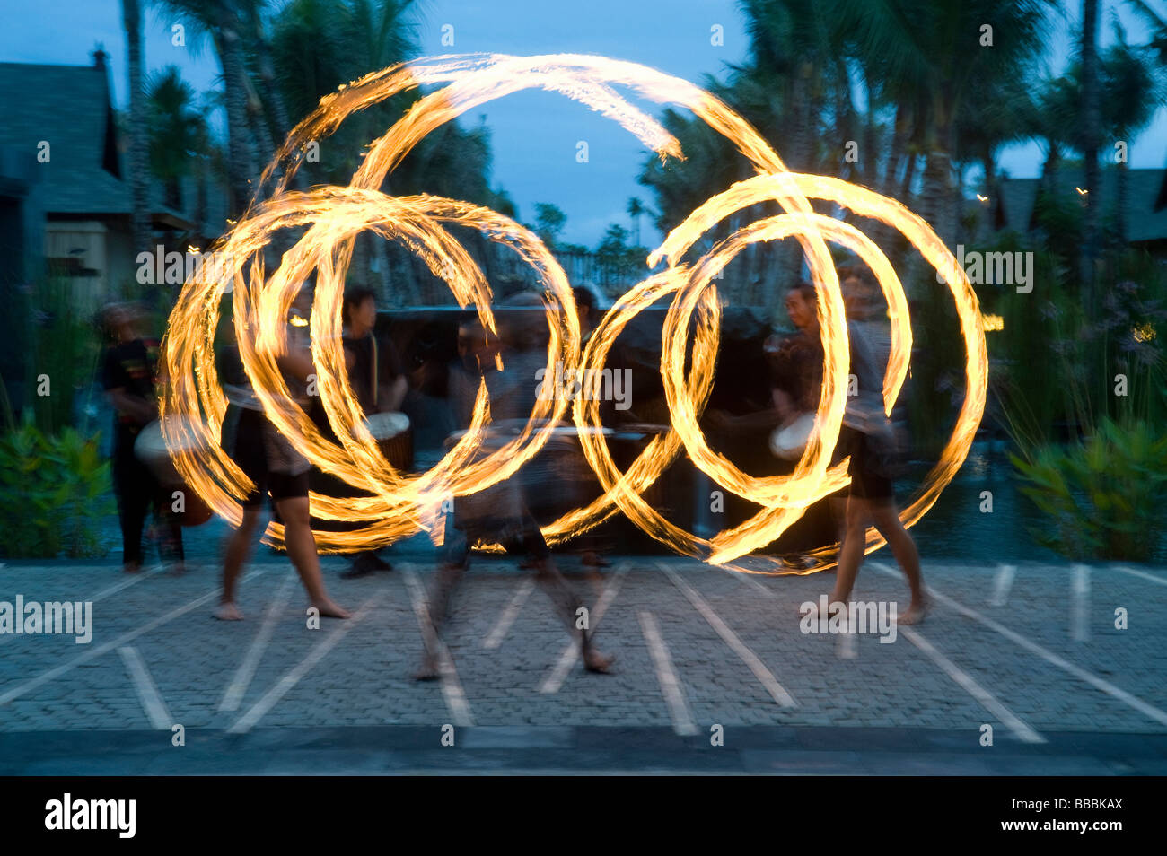 Three fire-twirlers performing Stock Photo - Alamy