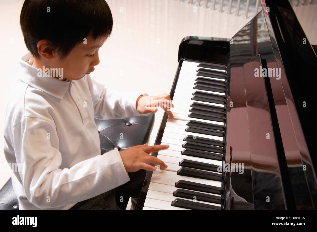 Little boy playing piano Stock Photo - Alamy