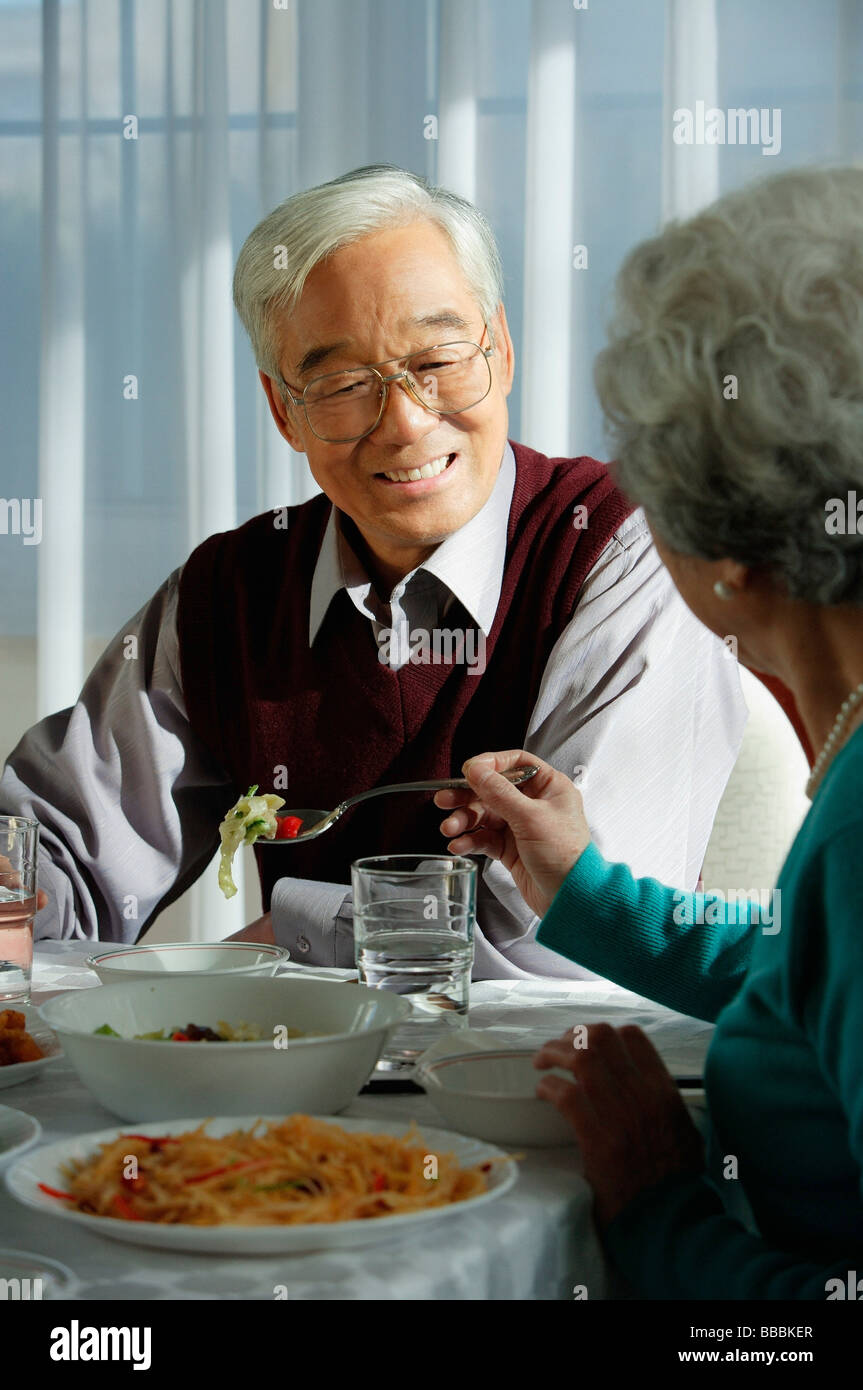 Elderly couple at dinner table Stock Photo - Alamy