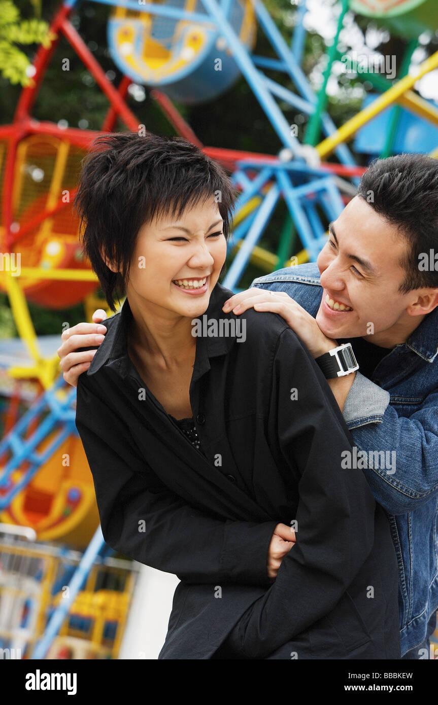 Couple at playground, laughing Stock Photo - Alamy