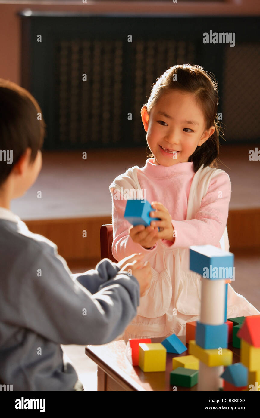Young children playing with building blocks Stock Photo - Alamy