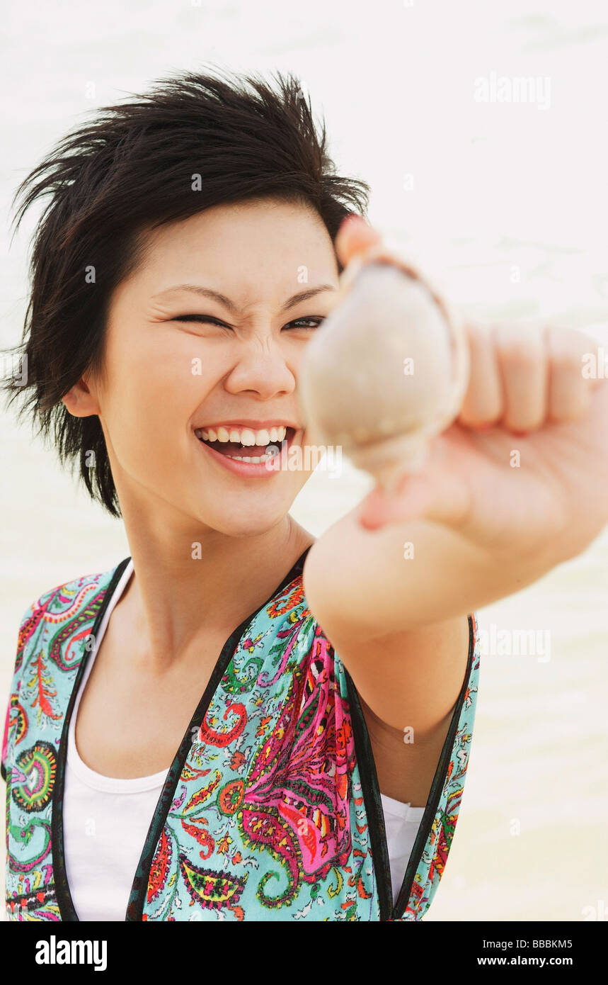Woman holding shell Stock Photo - Alamy
