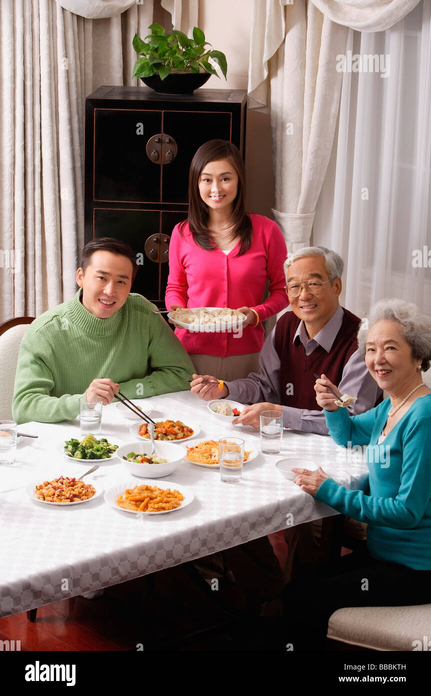 Family at dinner table having traditional food Stock Photo - Alamy