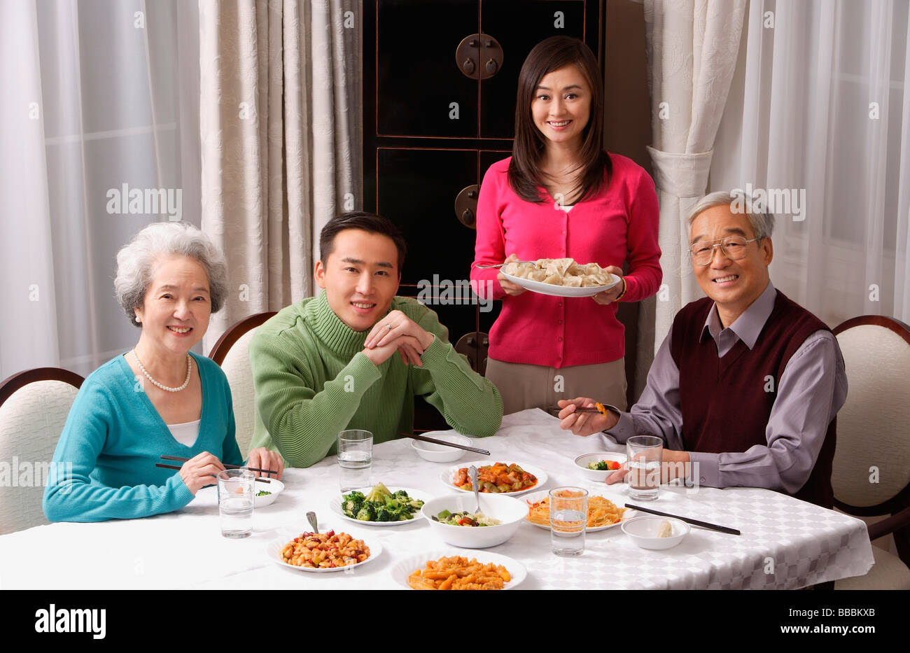 Family at dinner table having traditional food Stock Photo - Alamy